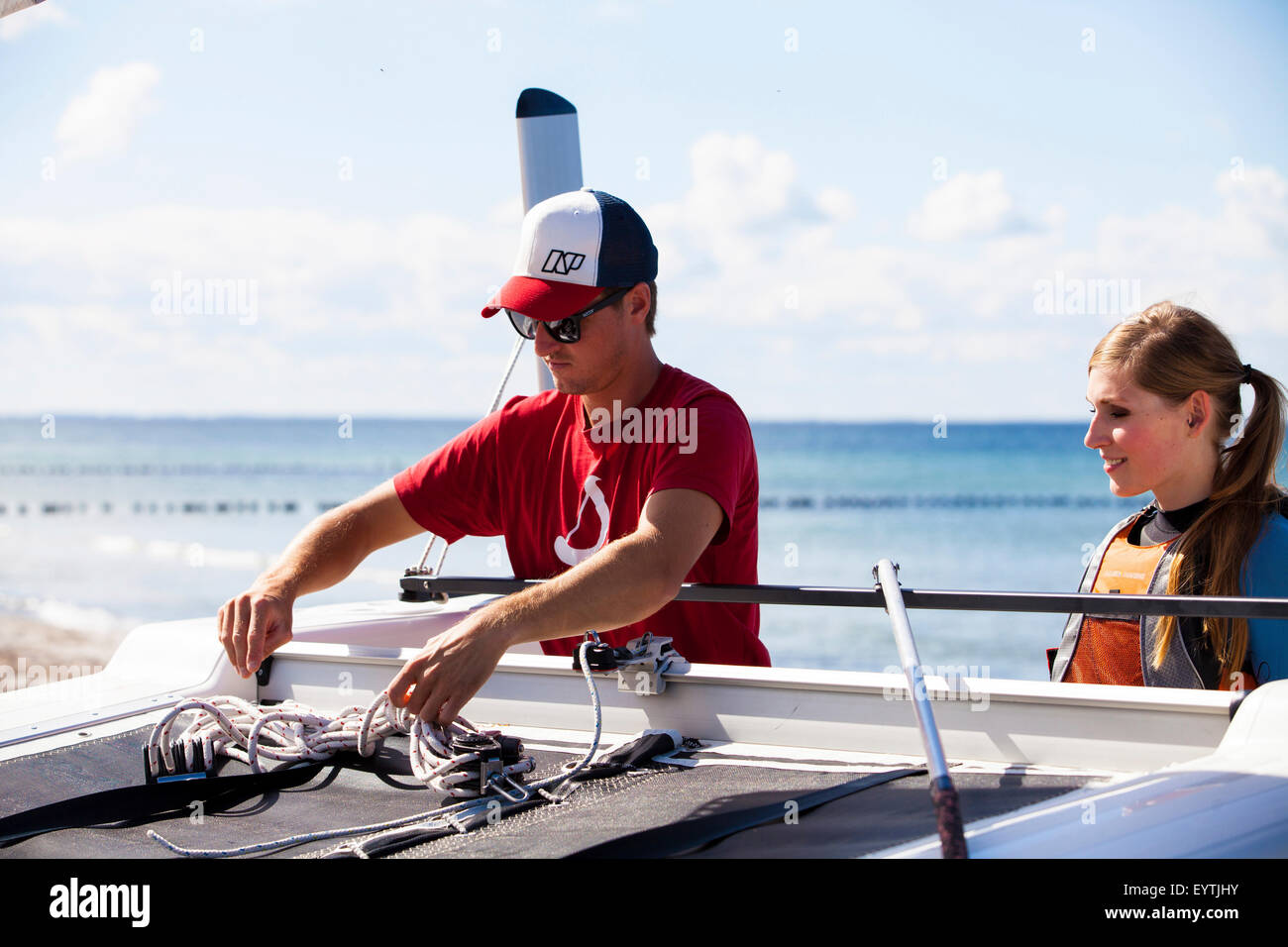 Sail lessons on catamaran, instructor, preparations, pupil is watching ...