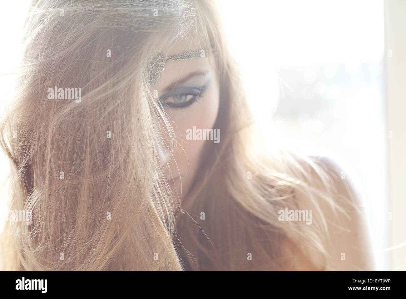 Portrait of a young woman, downcast look Stock Photo - Alamy