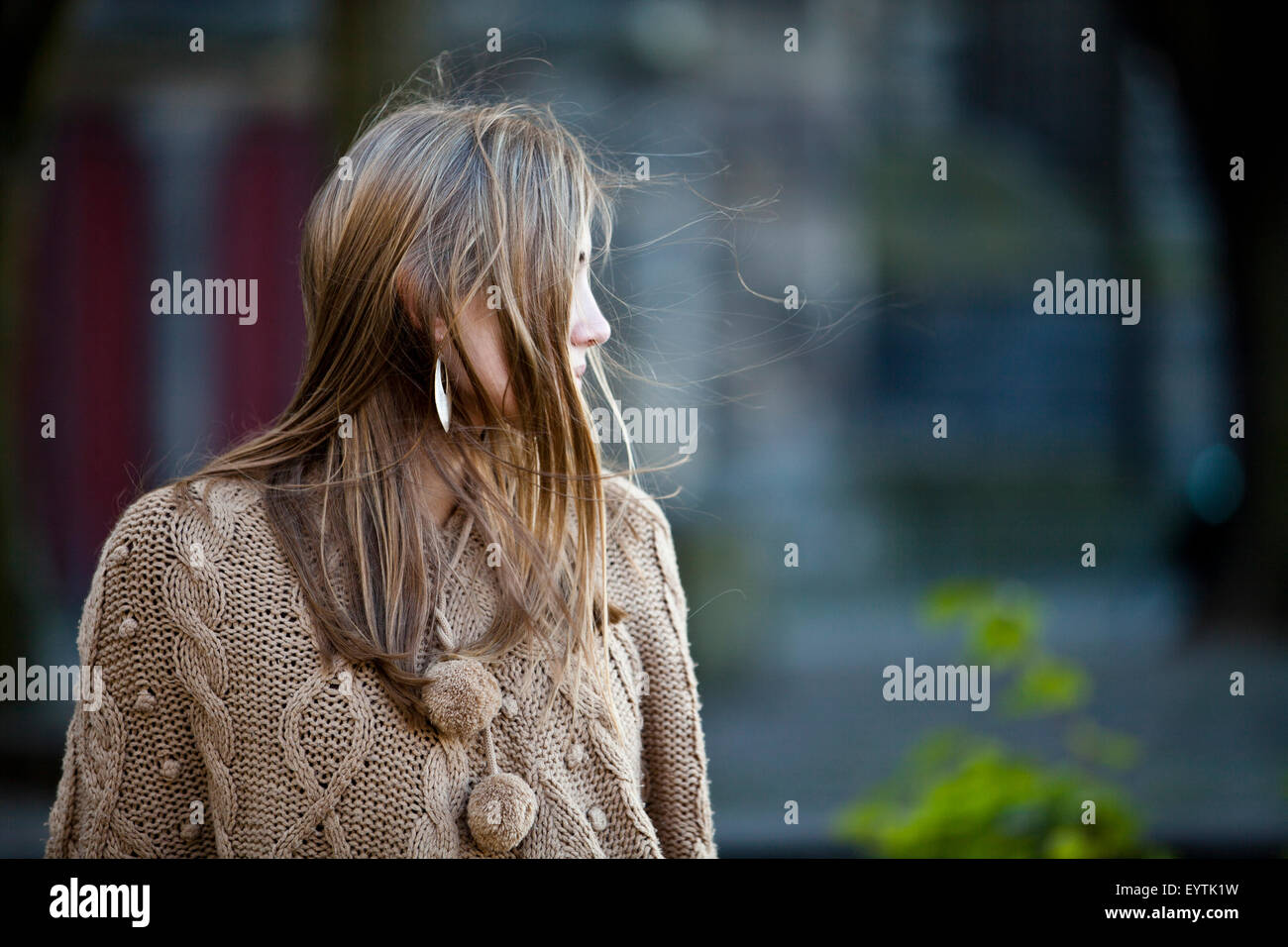 Young woman turning sidewards Stock Photo - Alamy