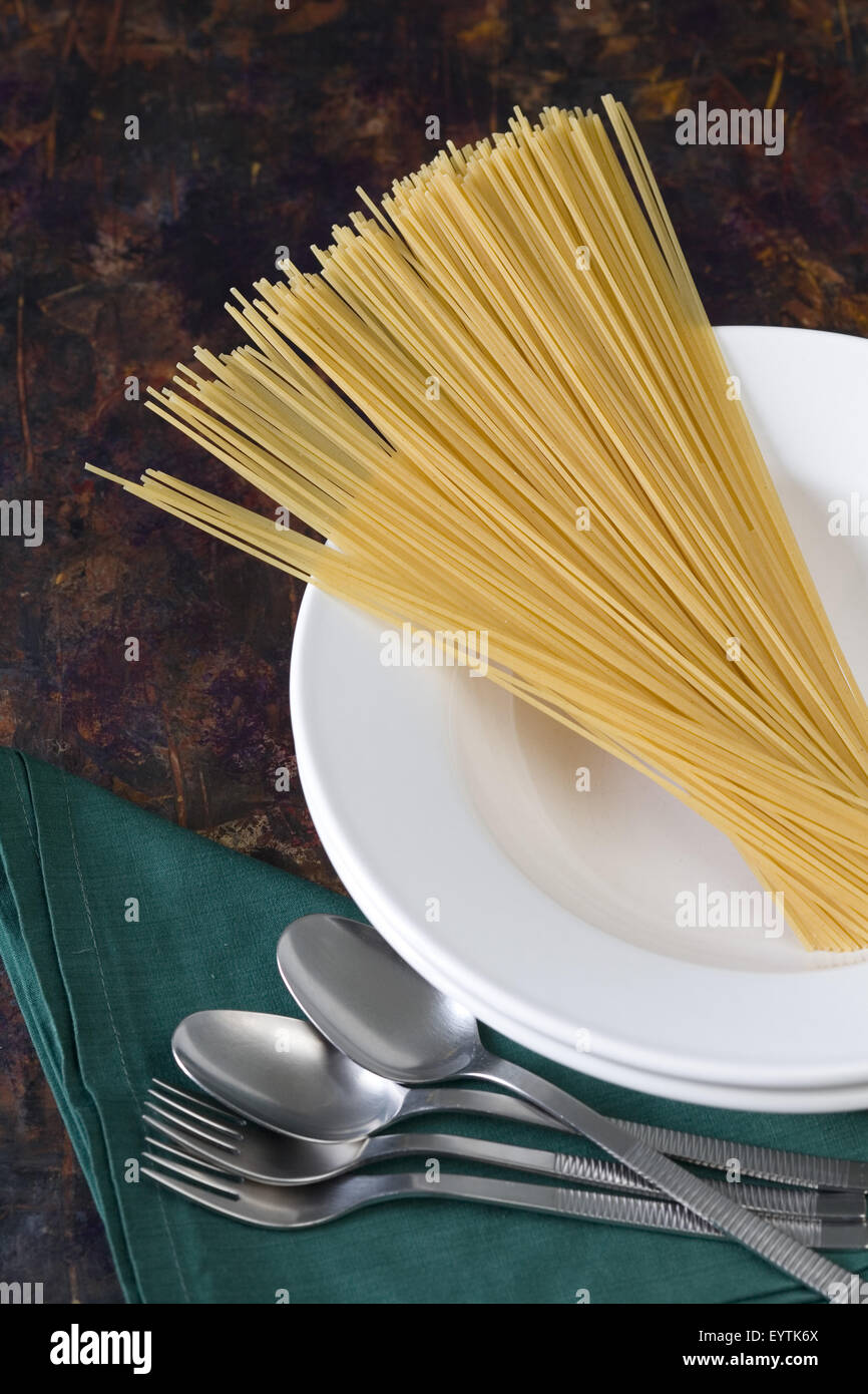 Raw spaghetti on spaghetti plate Stock Photo - Alamy
