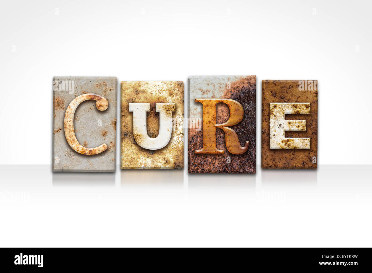 The word "CURE" written in rusty metal letterpress type isolated on a ...