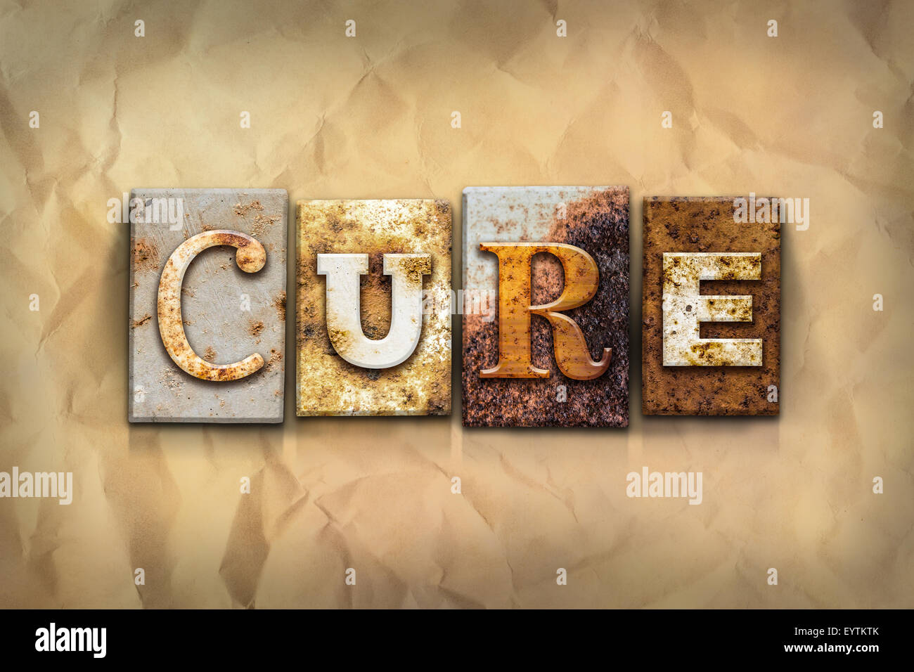 The word "CURE" written in rusty metal letterpress type on a crumbled ...