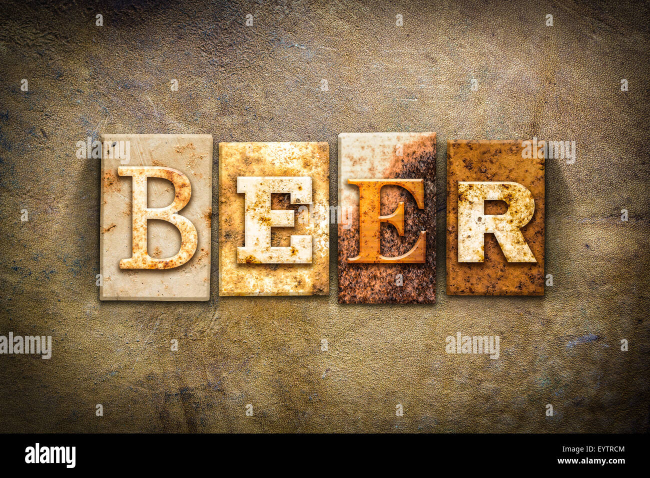 The word "BEER" written in rusty metal letterpress type on an old aged ...