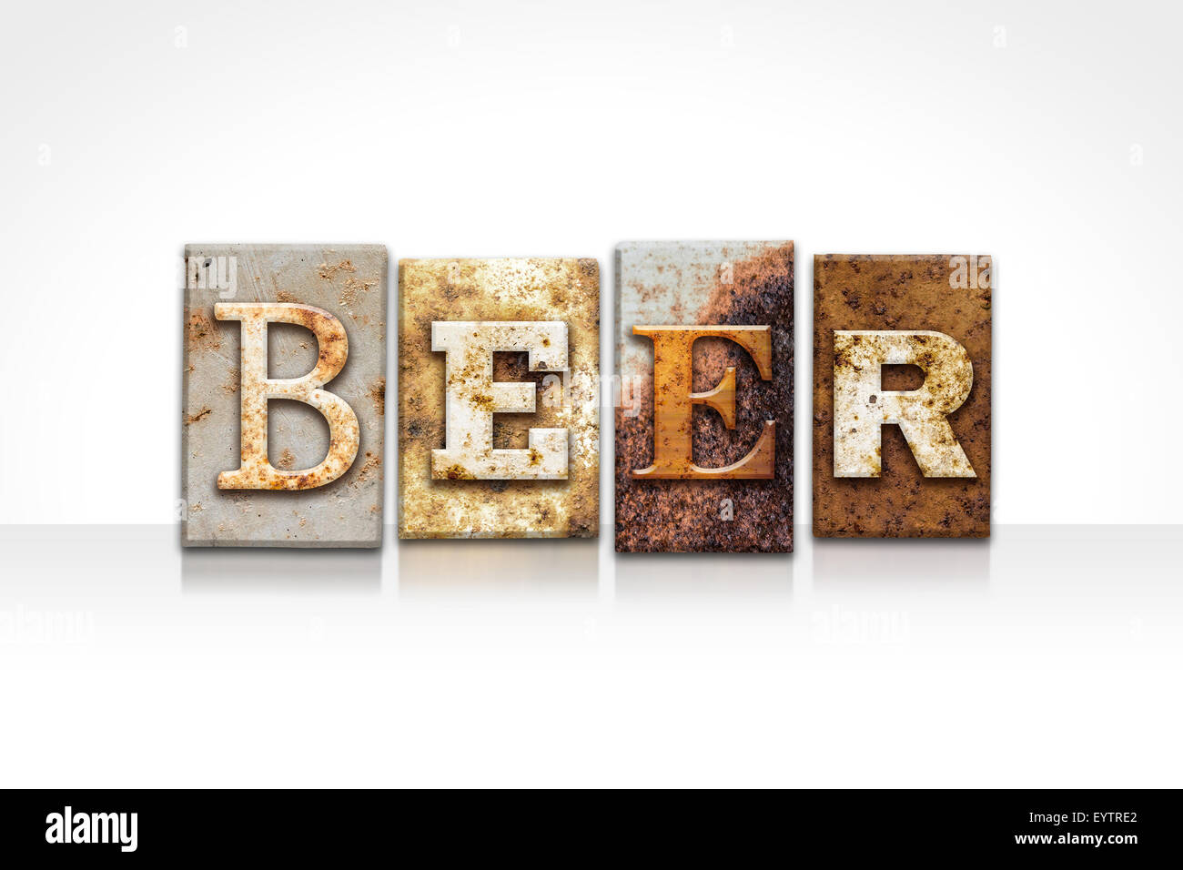 The word "BEER" written in rusty metal letterpress type isolated on a ...