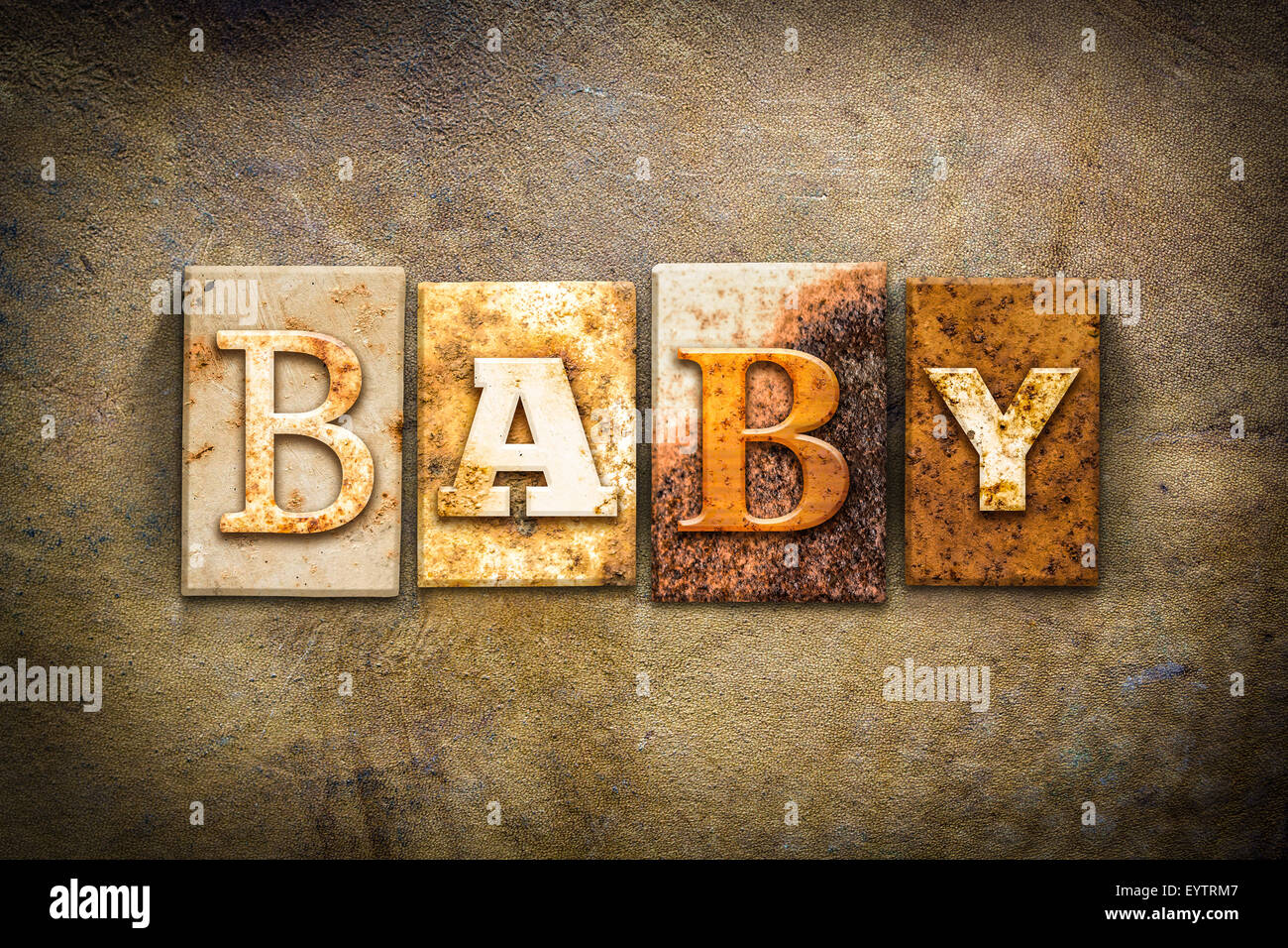 The word "BABY" written in rusty metal letterpress type on an old aged ...