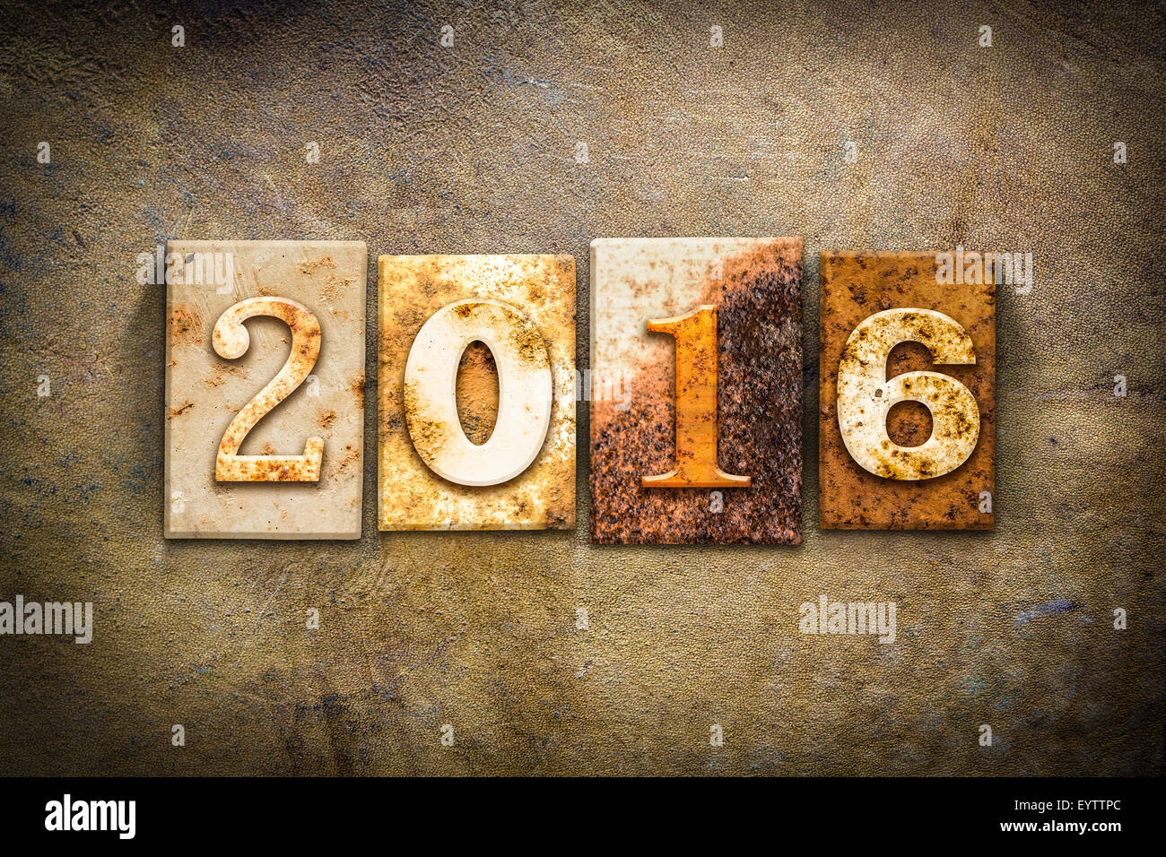 The word "2016" written in rusty metal letterpress type on an old aged ...