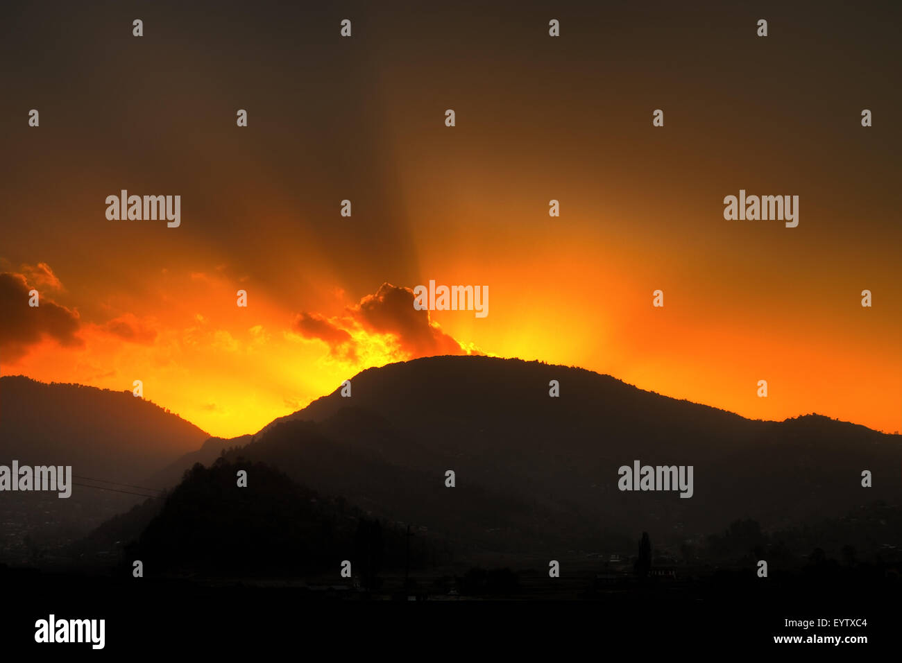 ray of sunlight escaping behind a hill Stock Photo - Alamy