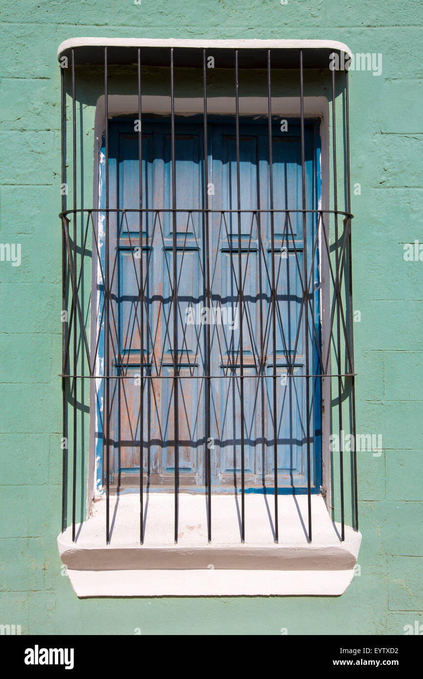 Detail of wooden window with bars in classical colonial architecture in ...