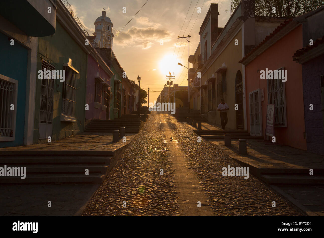 Sunset in old colonial street with a unrecognizable man walking, very ...