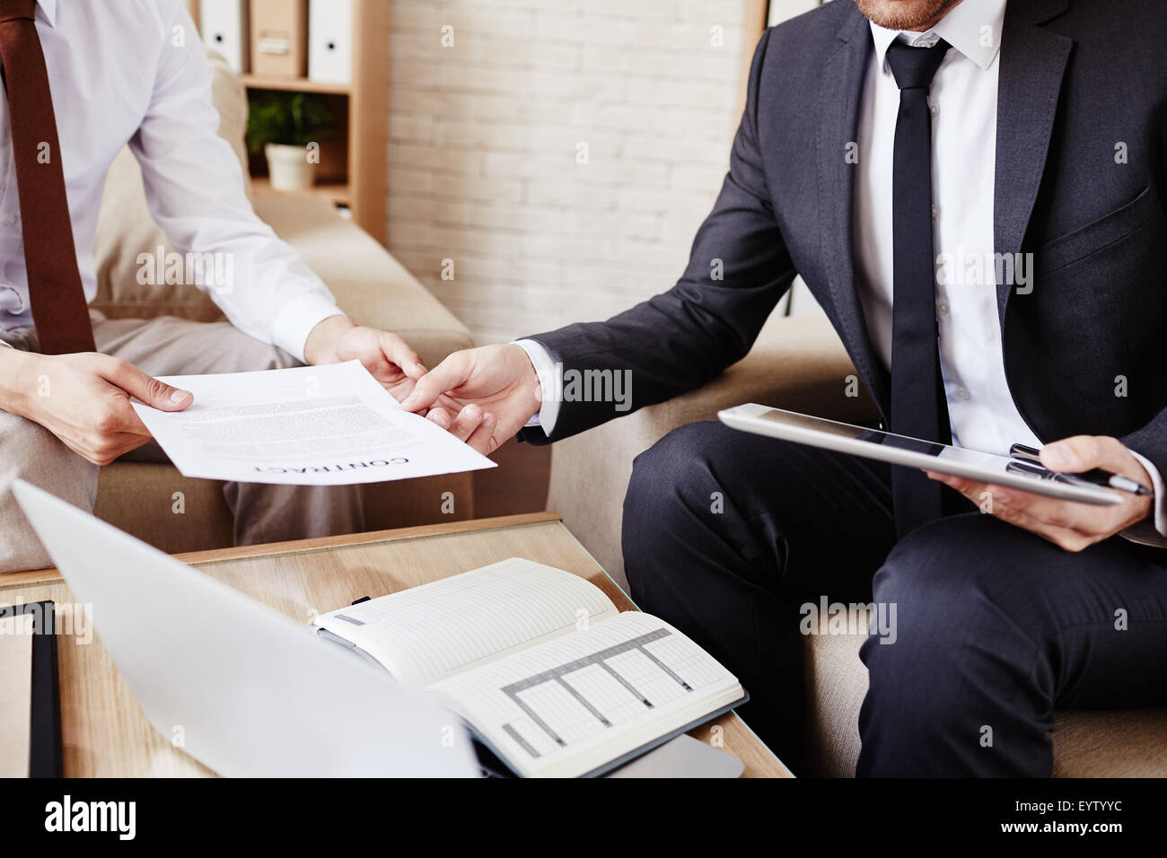 Businessman giving document to his colleague at meeting Stock Photo - Alamy