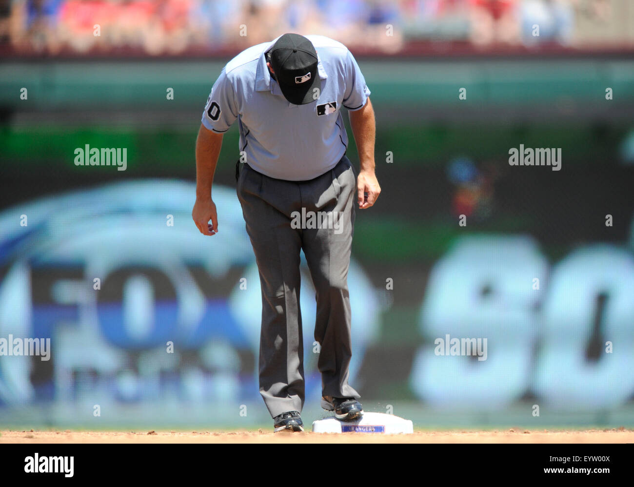 AUG 02, 2015: MLB Umpire Mark Ripperger #90 checks the second base bag ...