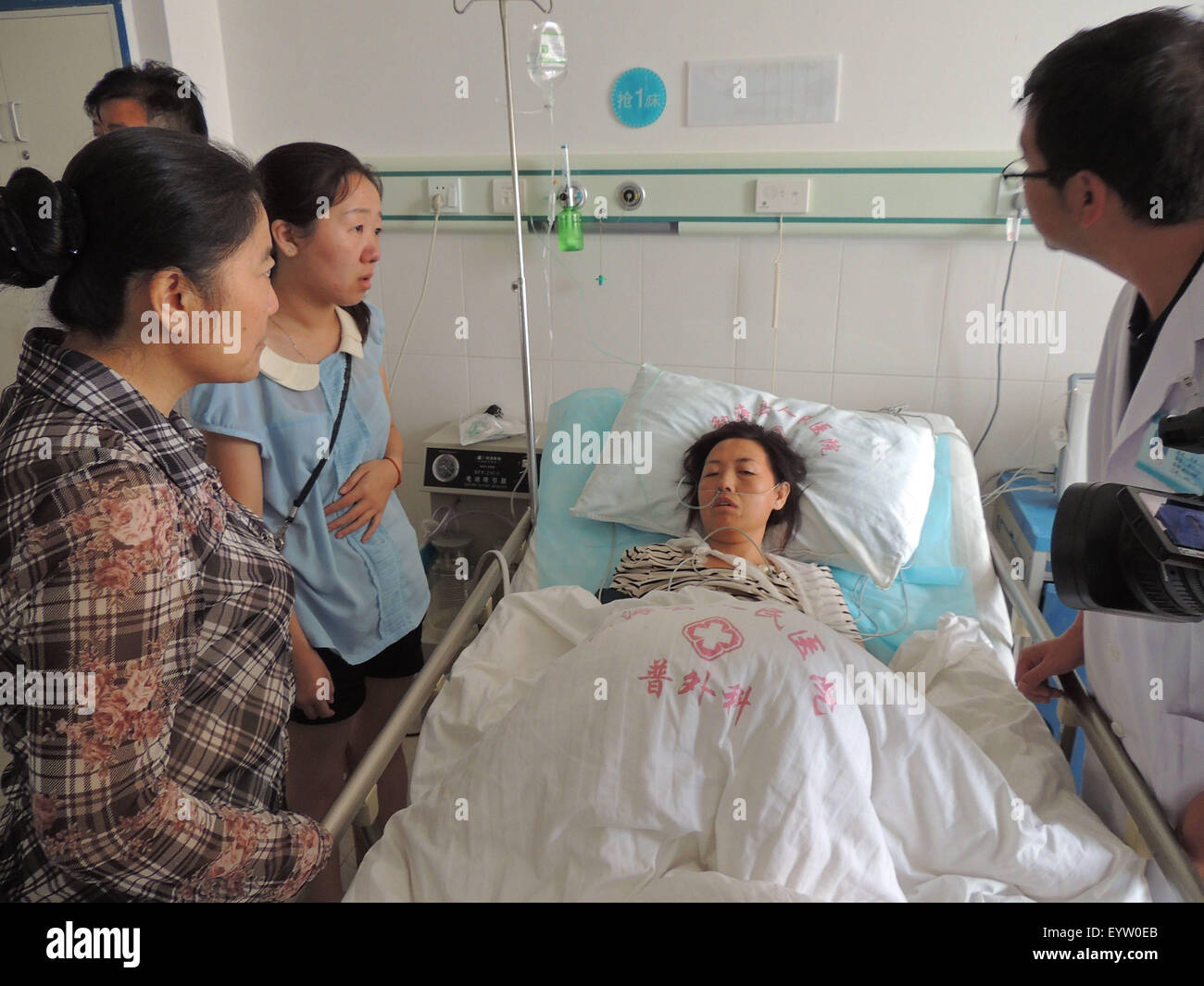 Menghai, China's Yunnan Province. 3rd Aug, 2015. Doctors examine an ...