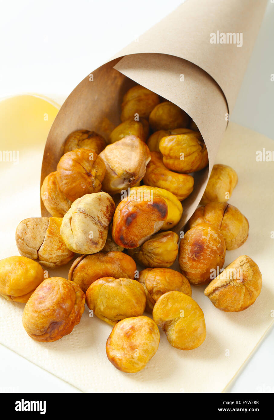 Peeled roasted chestnuts spill out of a paper cone Stock Photo - Alamy