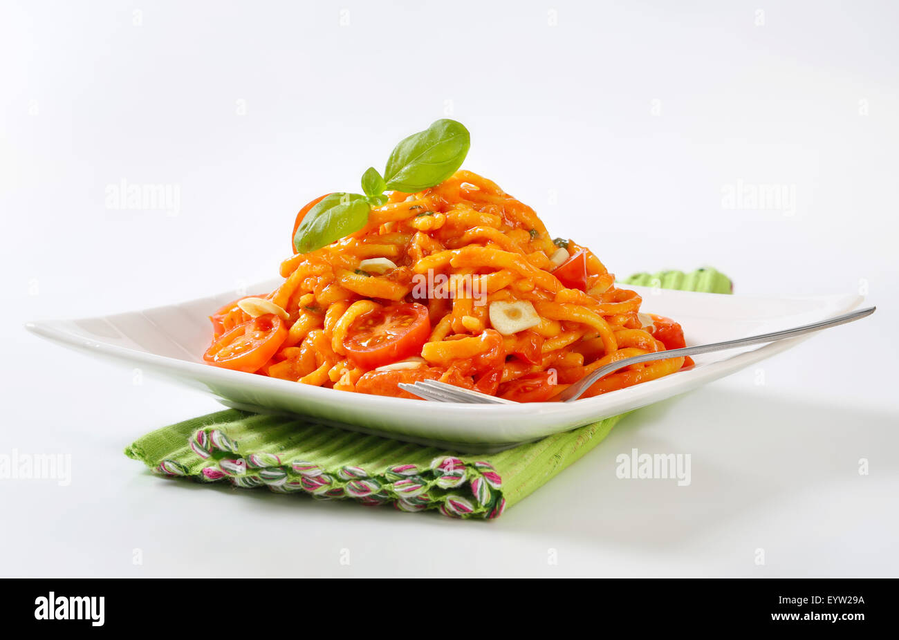 Thin spaetzle in garlic tomato sauce Stock Photo - Alamy