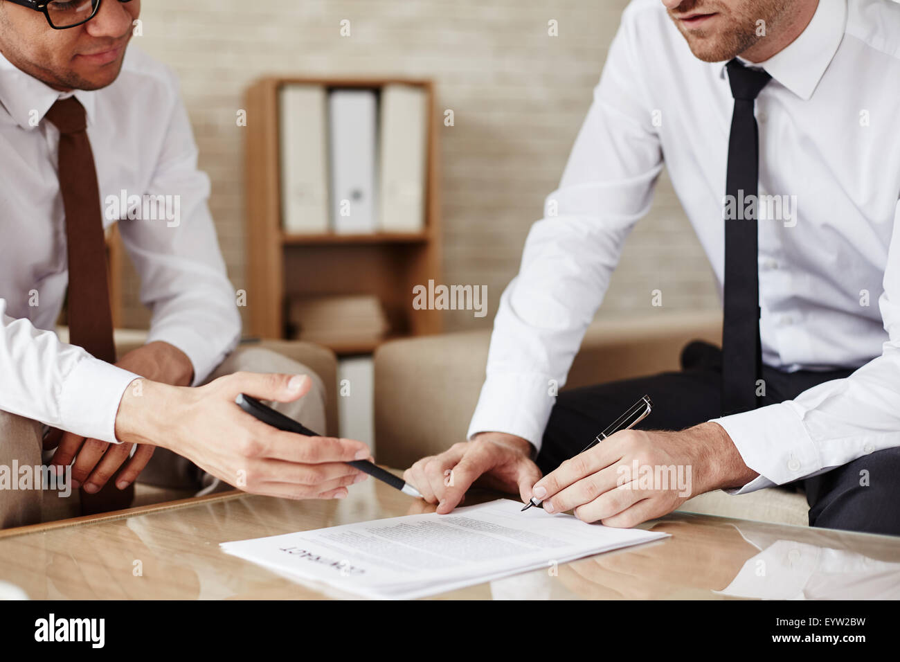 Two employees discussing contract at meeting Stock Photo - Alamy