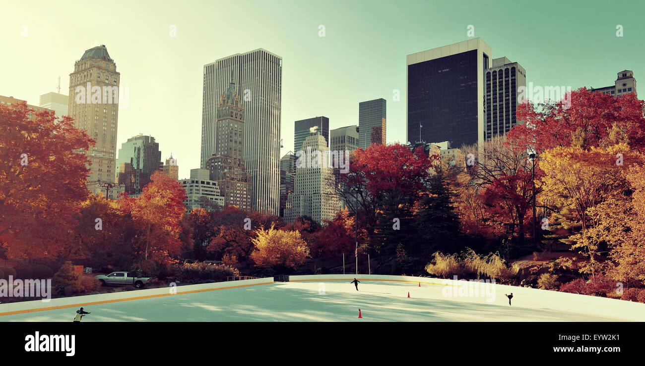 Central Park Autumn ice rink midtown skyline in Manhattan New York City ...