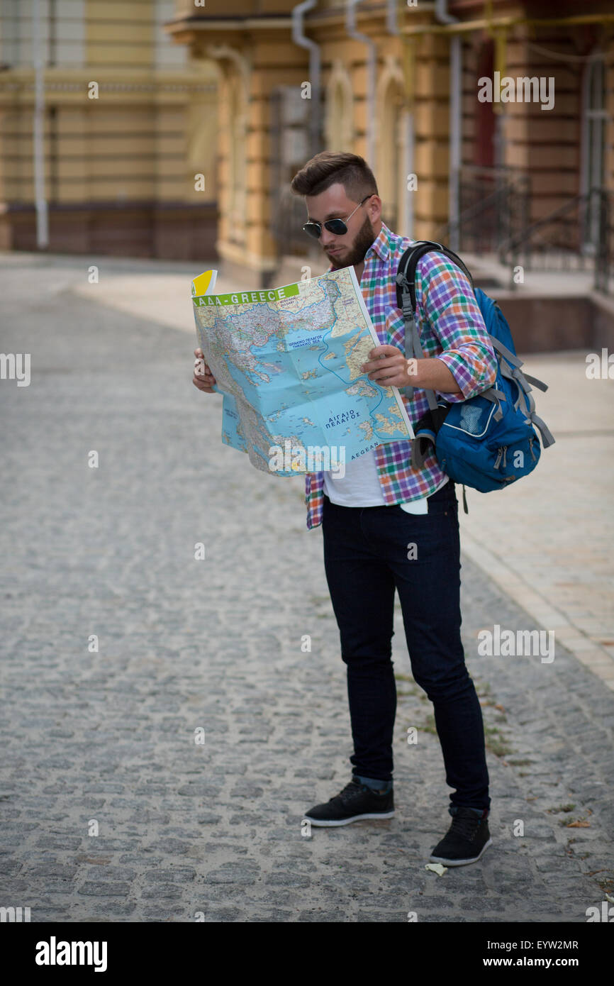 Young hipster man with map Stock Photo - Alamy