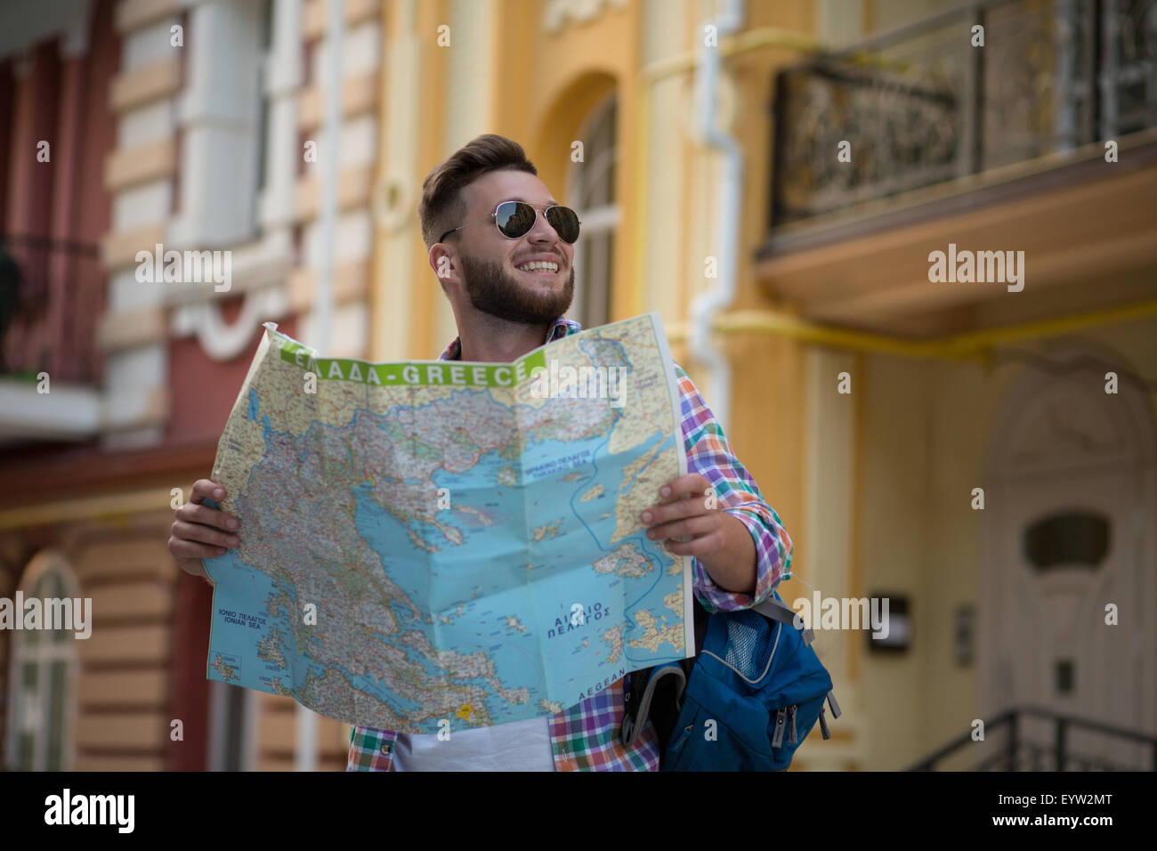Young hipster man with map Stock Photo - Alamy