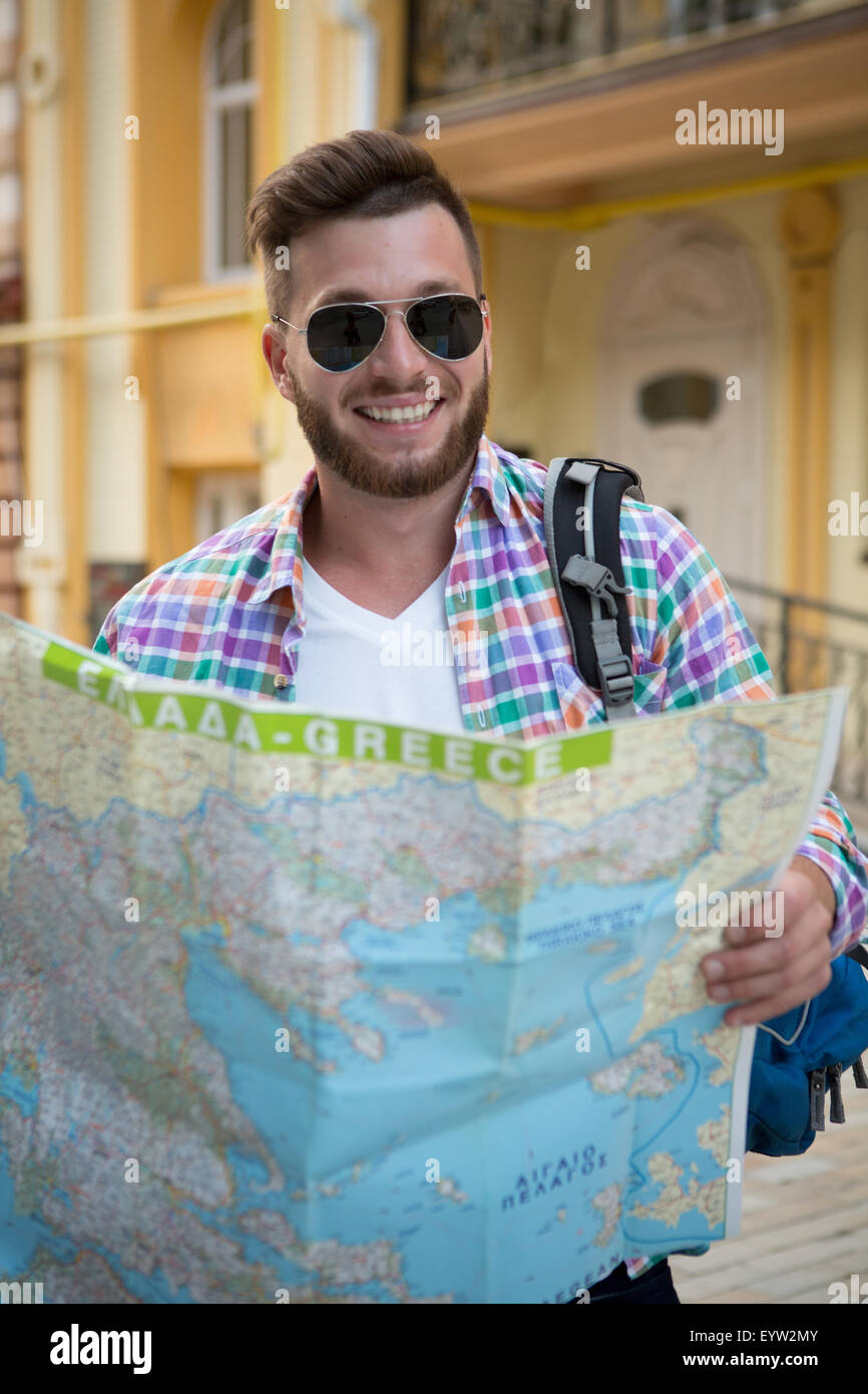 Young hipster man with map Stock Photo - Alamy