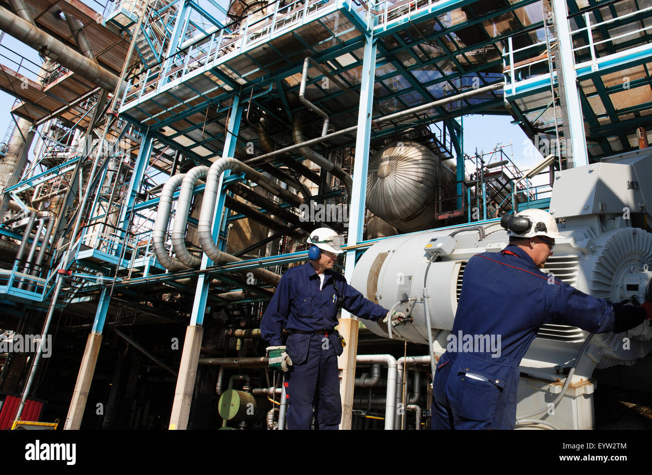 oil workers inside large refinery Stock Photo - Alamy