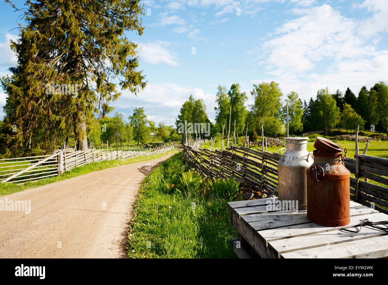 old large milk-jugs in a rural landscape, culture Stock Photo - Alamy