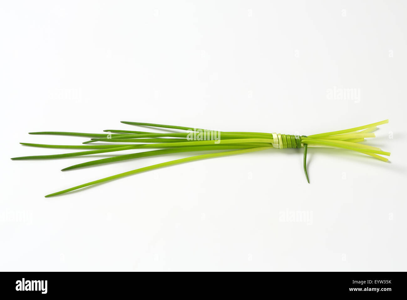 Bunch of fresh chives on white background Stock Photo - Alamy