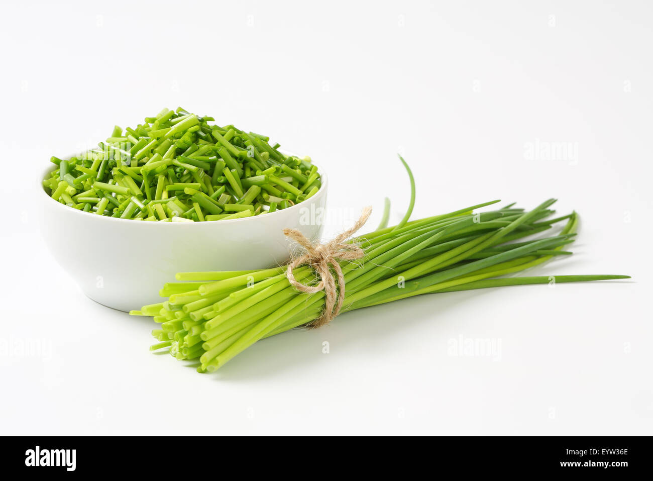 Studio shot of fresh chives - bunch and chopped Stock Photo - Alamy