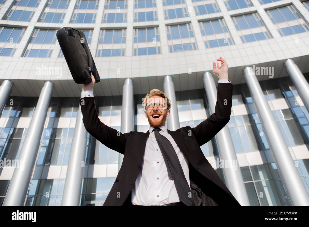Successful businessman celebrating arms hi-res stock photography and ...