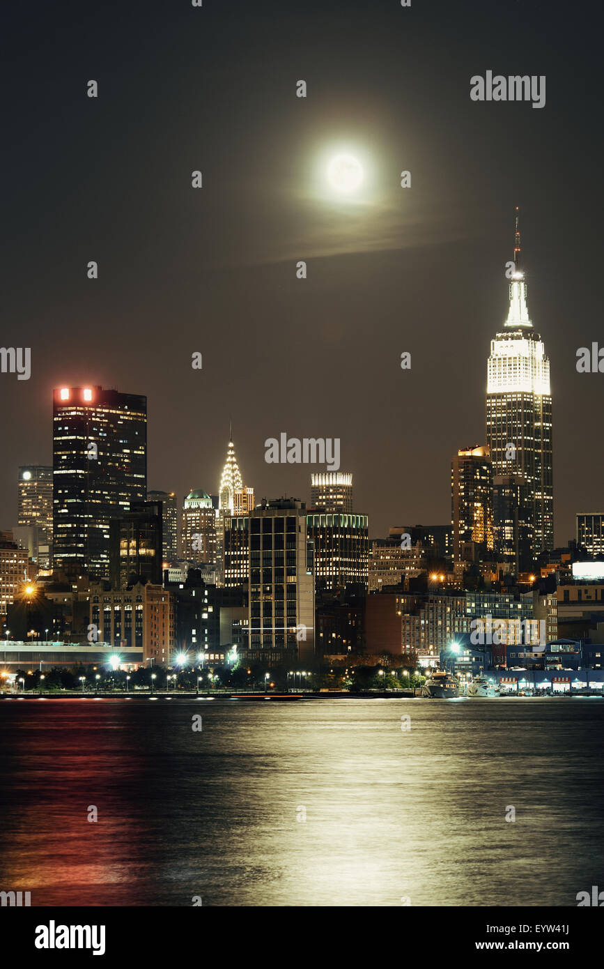 Moon rise over midtown Manhattan with city skyline at night Stock Photo ...