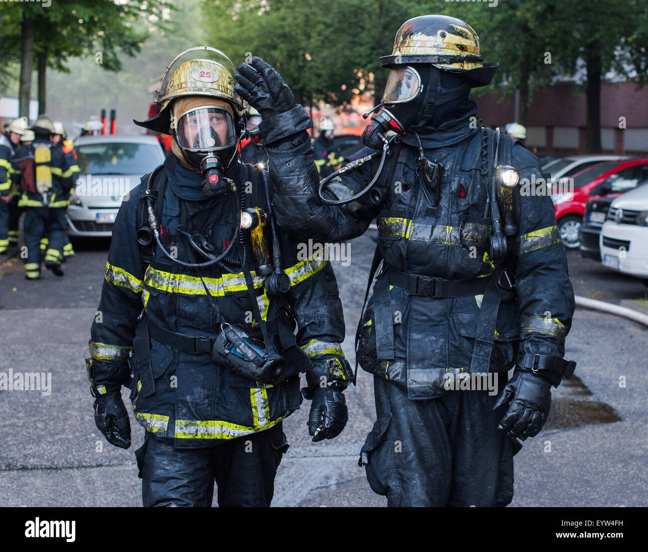 Hamburg, Germany. 04th Aug, 2015. Two firefighters covered in soot ...