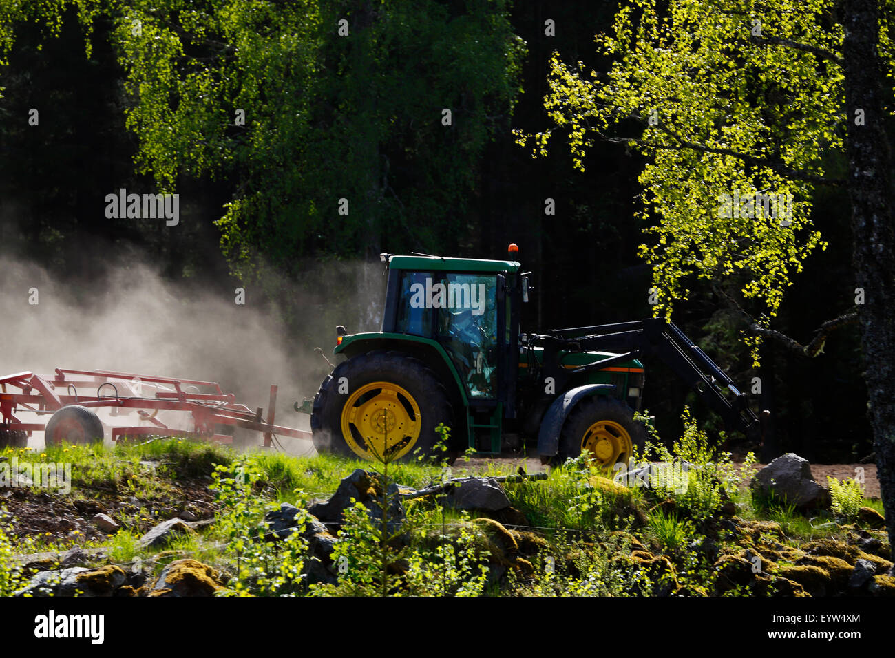 old vintage farming tractor at sunset Stock Photo - Alamy