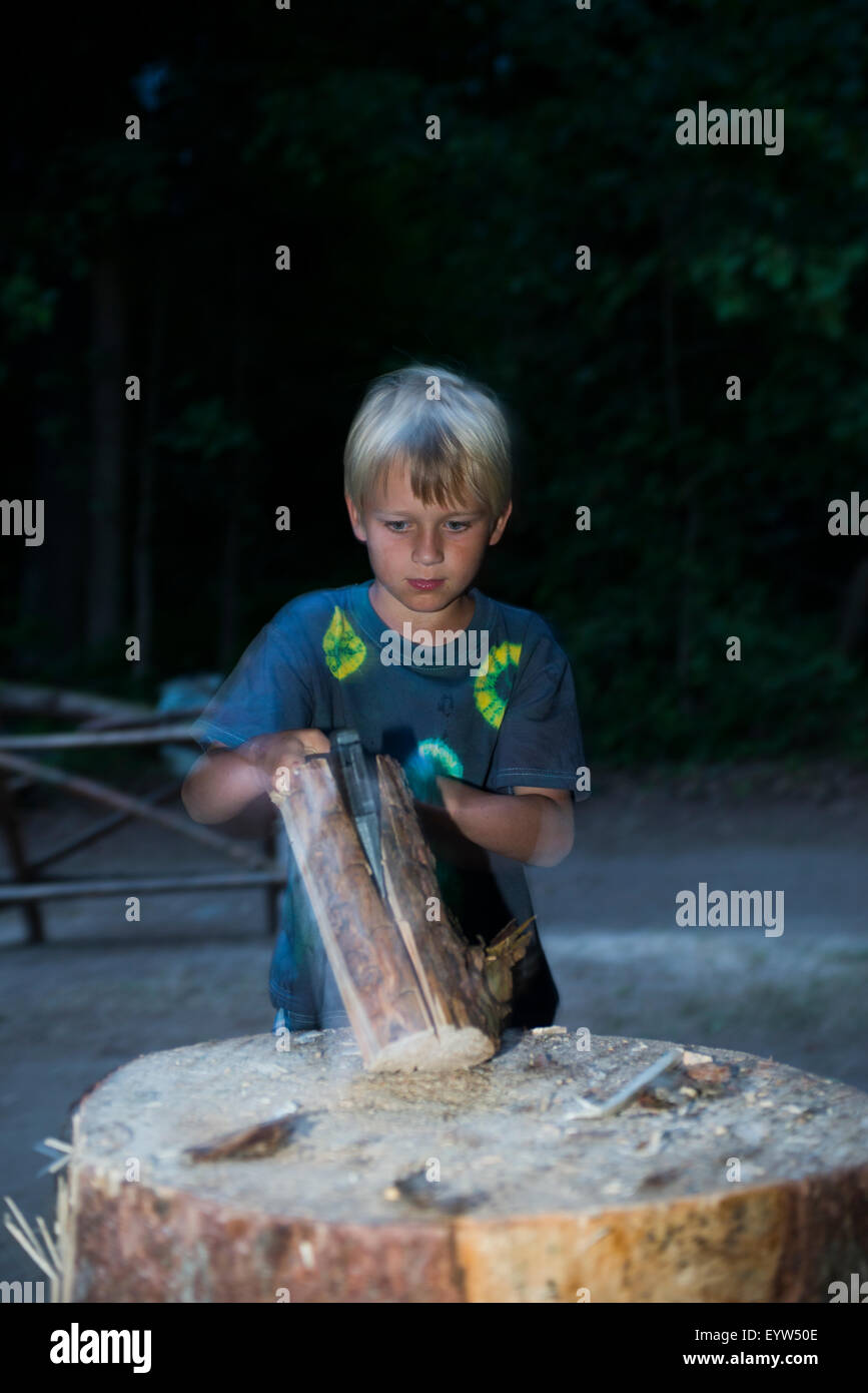 Child boy chopping wood alone, Splitting Logs Stock Photo - Alamy
