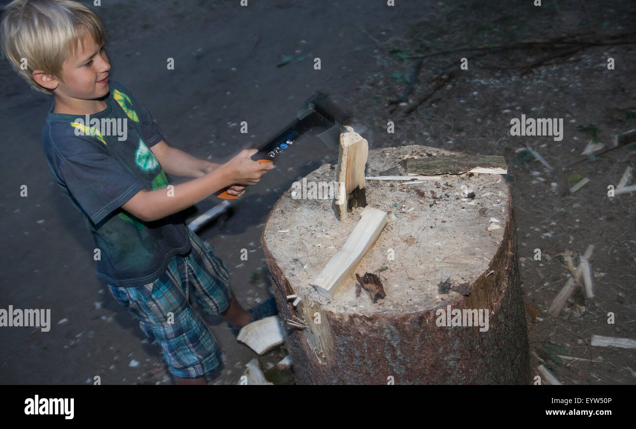 Child boy chopping wood alone, Splitting Logs Stock Photo - Alamy
