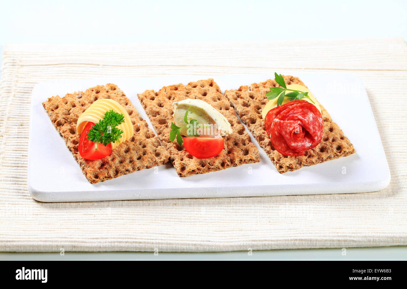 Whole grain crisp bread slices with various toppings Stock Photo - Alamy