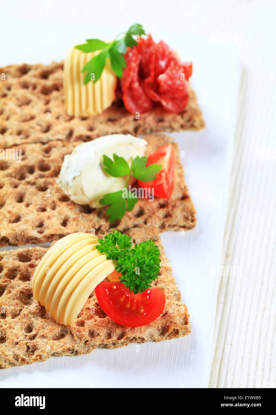 Whole grain crisp bread slices with various toppings Stock Photo - Alamy