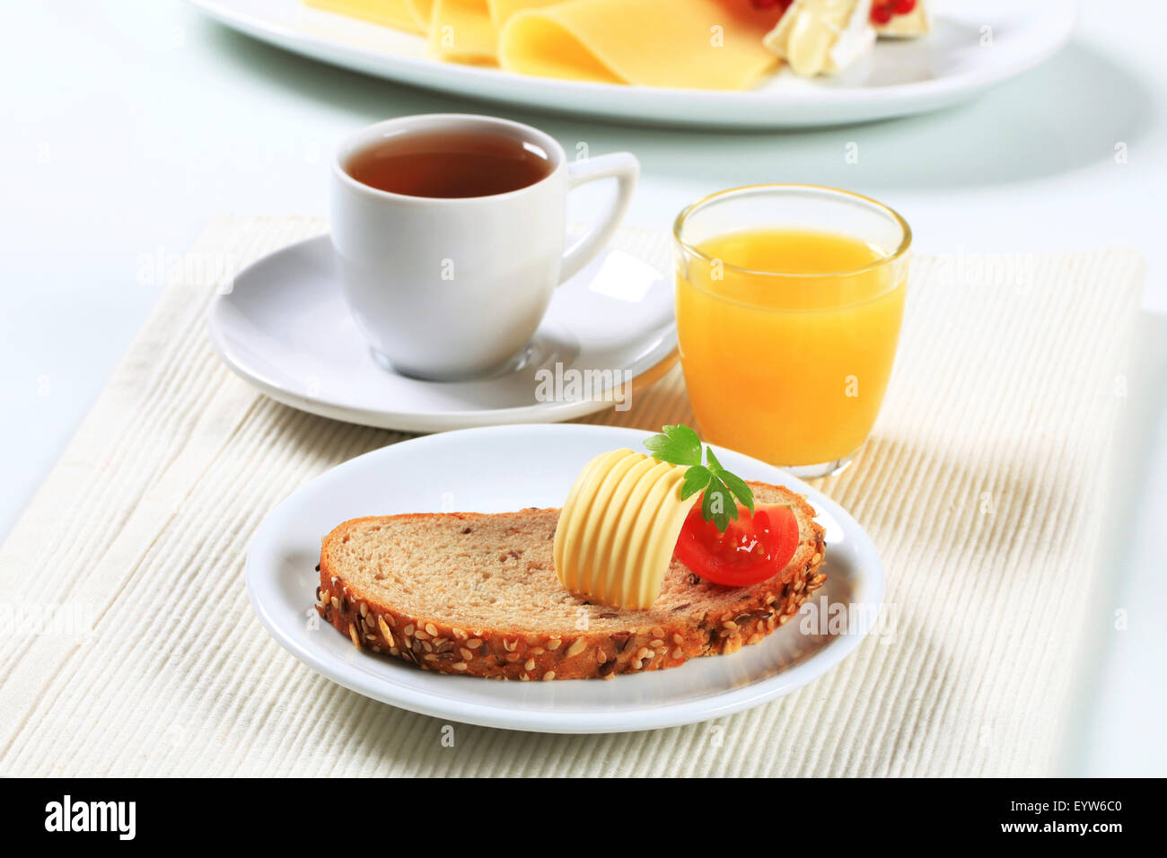 Bread with butter, cup of tea and orange juice - still life Stock Photo ...