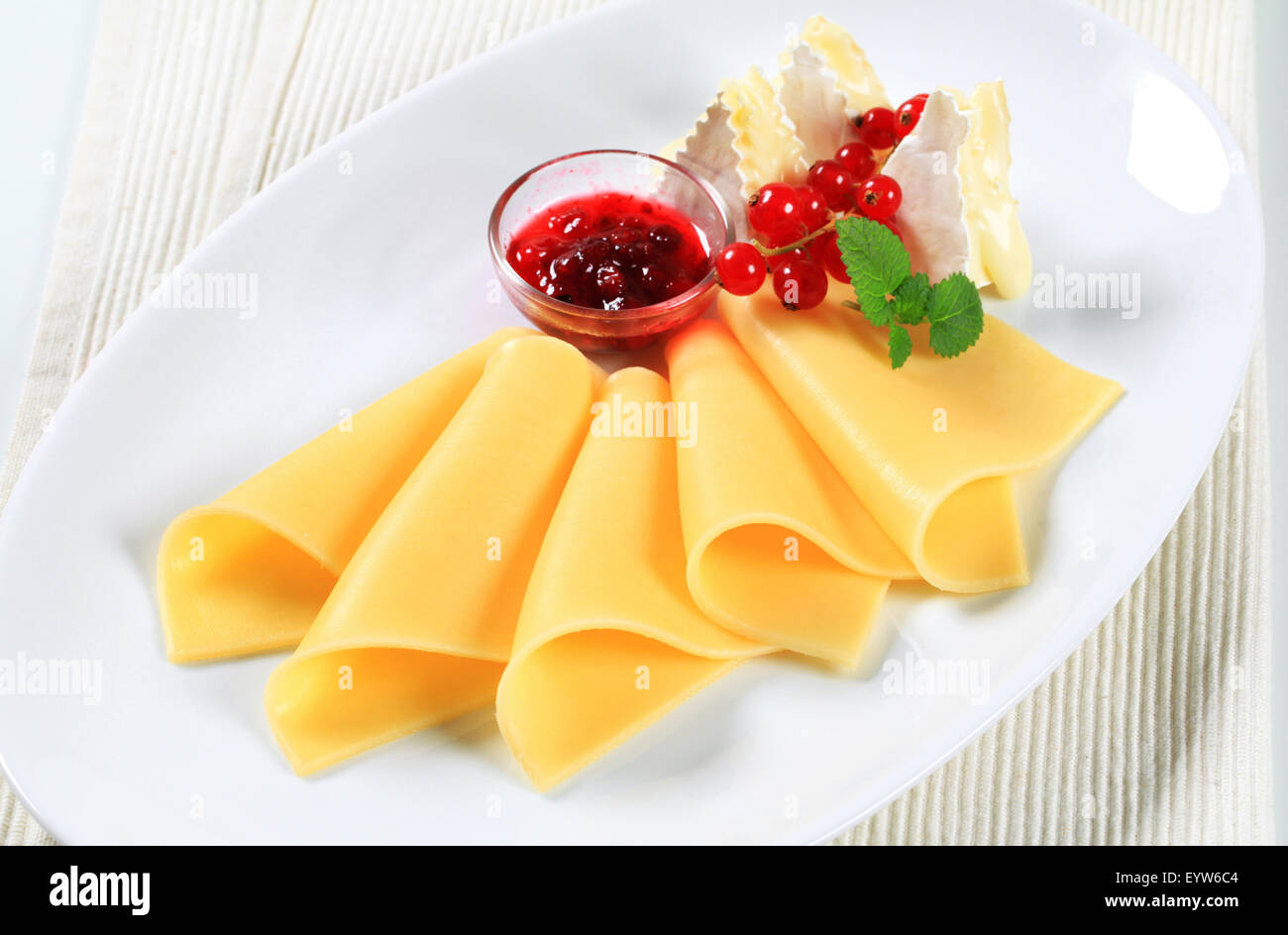 Two kinds of cheese and red currant sauce Stock Photo - Alamy