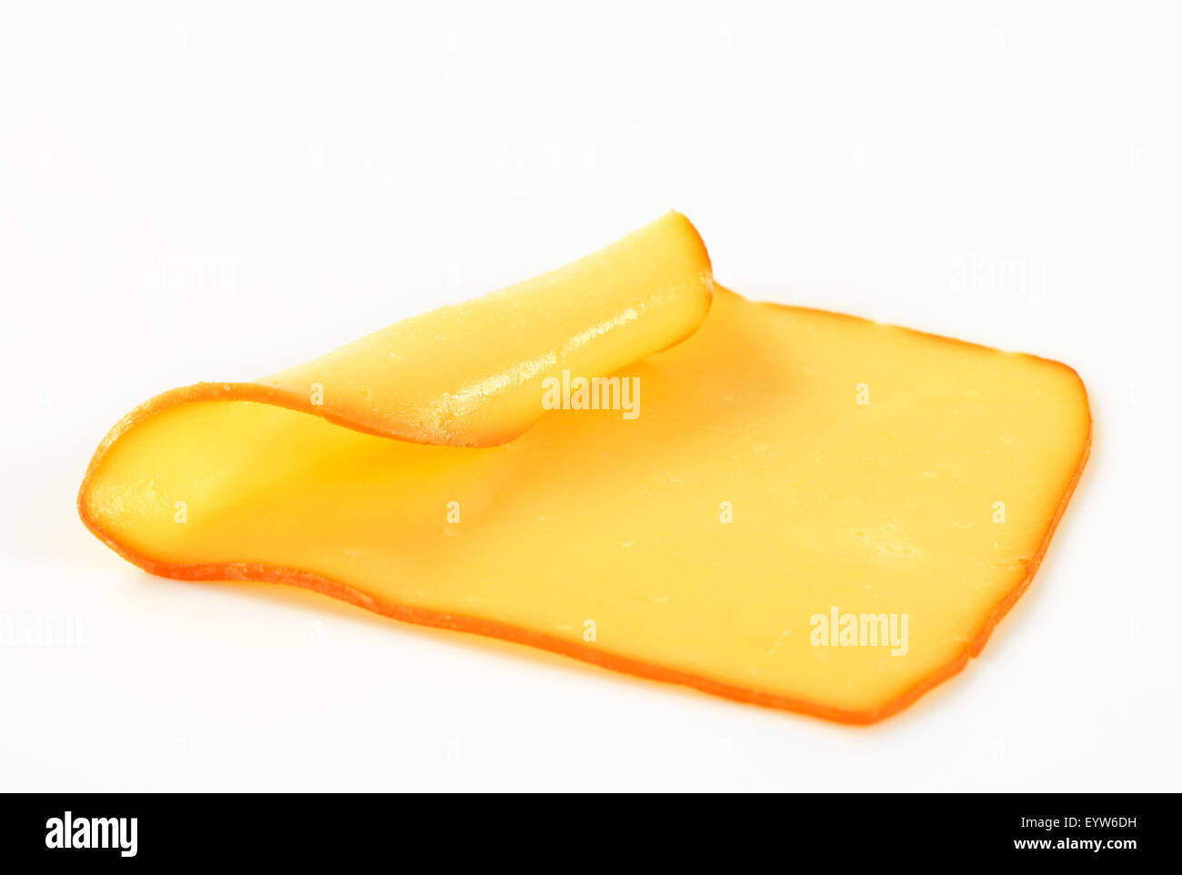 Thin slice of smoked yellow cheese Stock Photo - Alamy