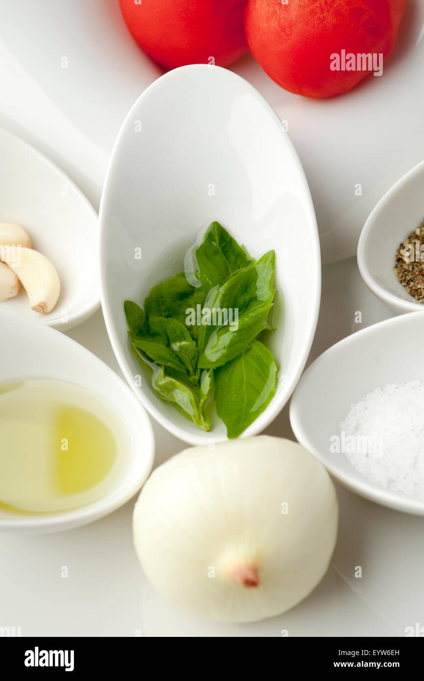 Still life with cooking ingredients in white utensils on white ...