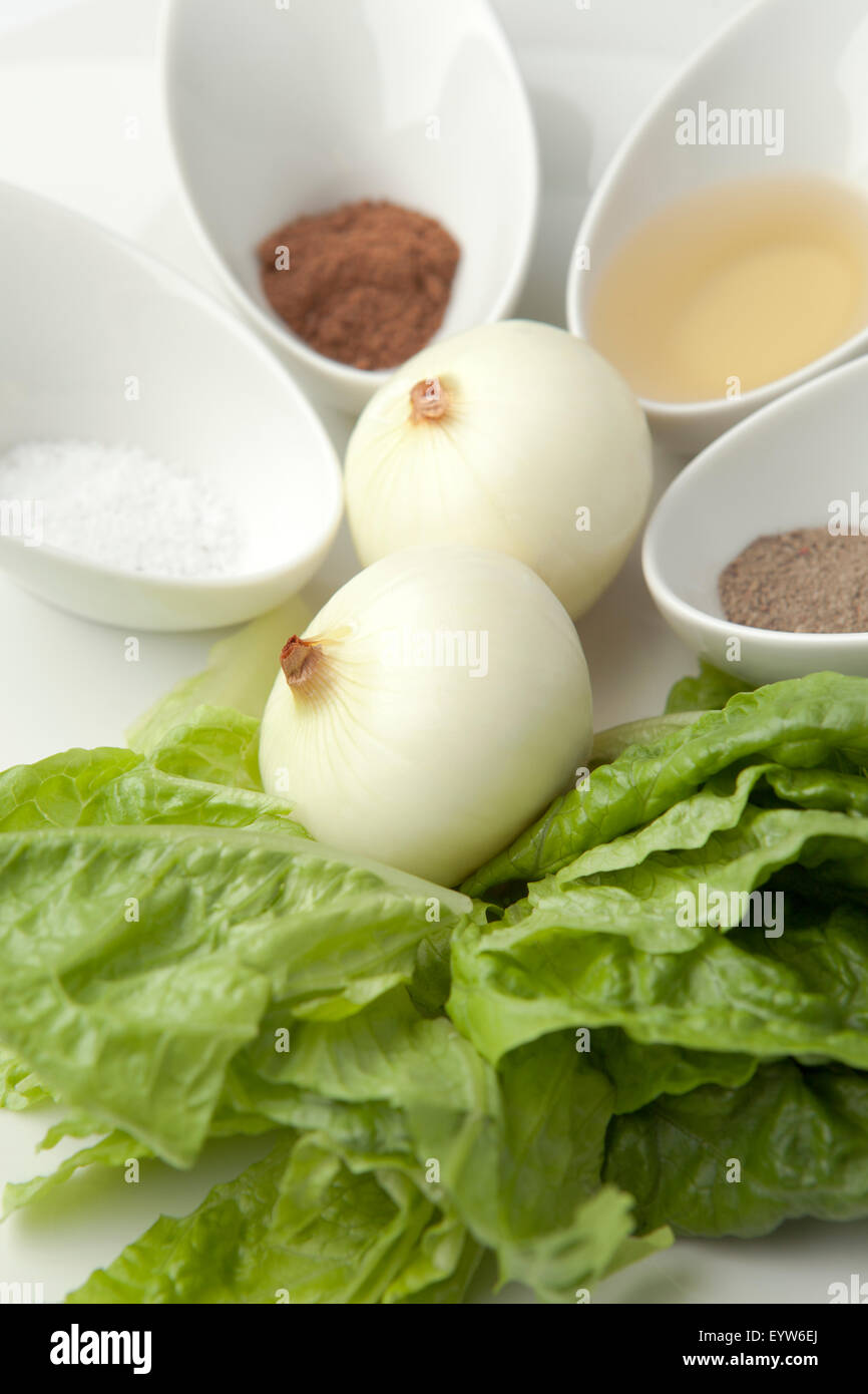 Still life with cooking ingredients in white utensils on white ...