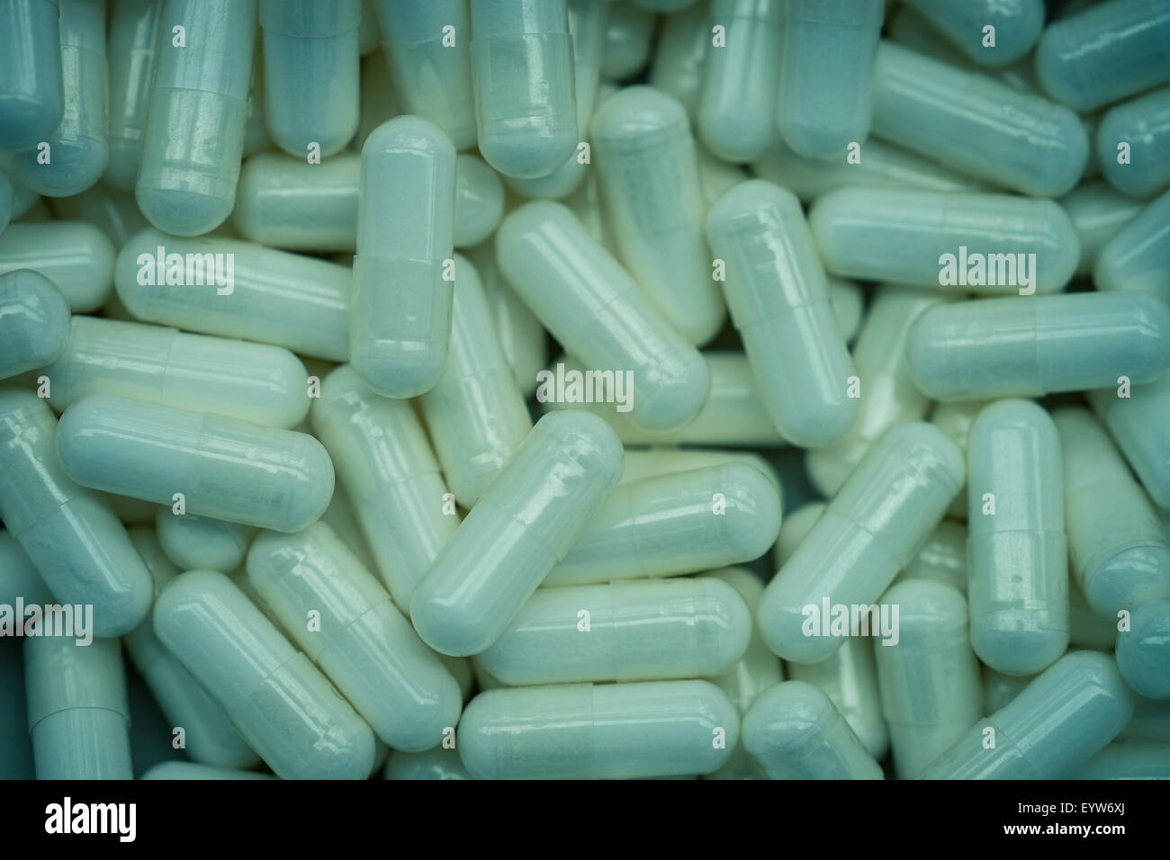 A heap of pills taken with slight green tinge Stock Photo - Alamy