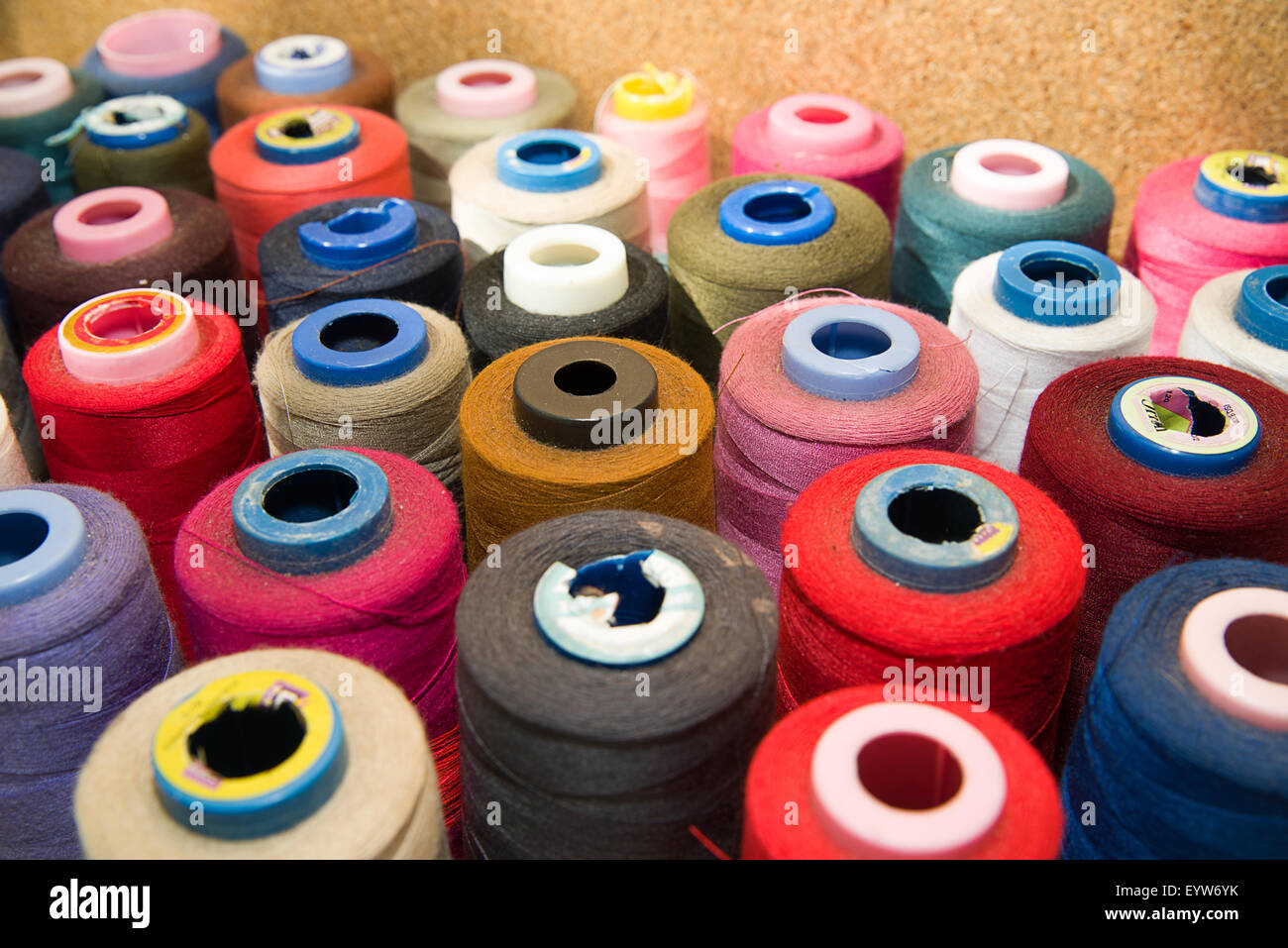 Many reels of colored threads standing on the table Stock Photo - Alamy