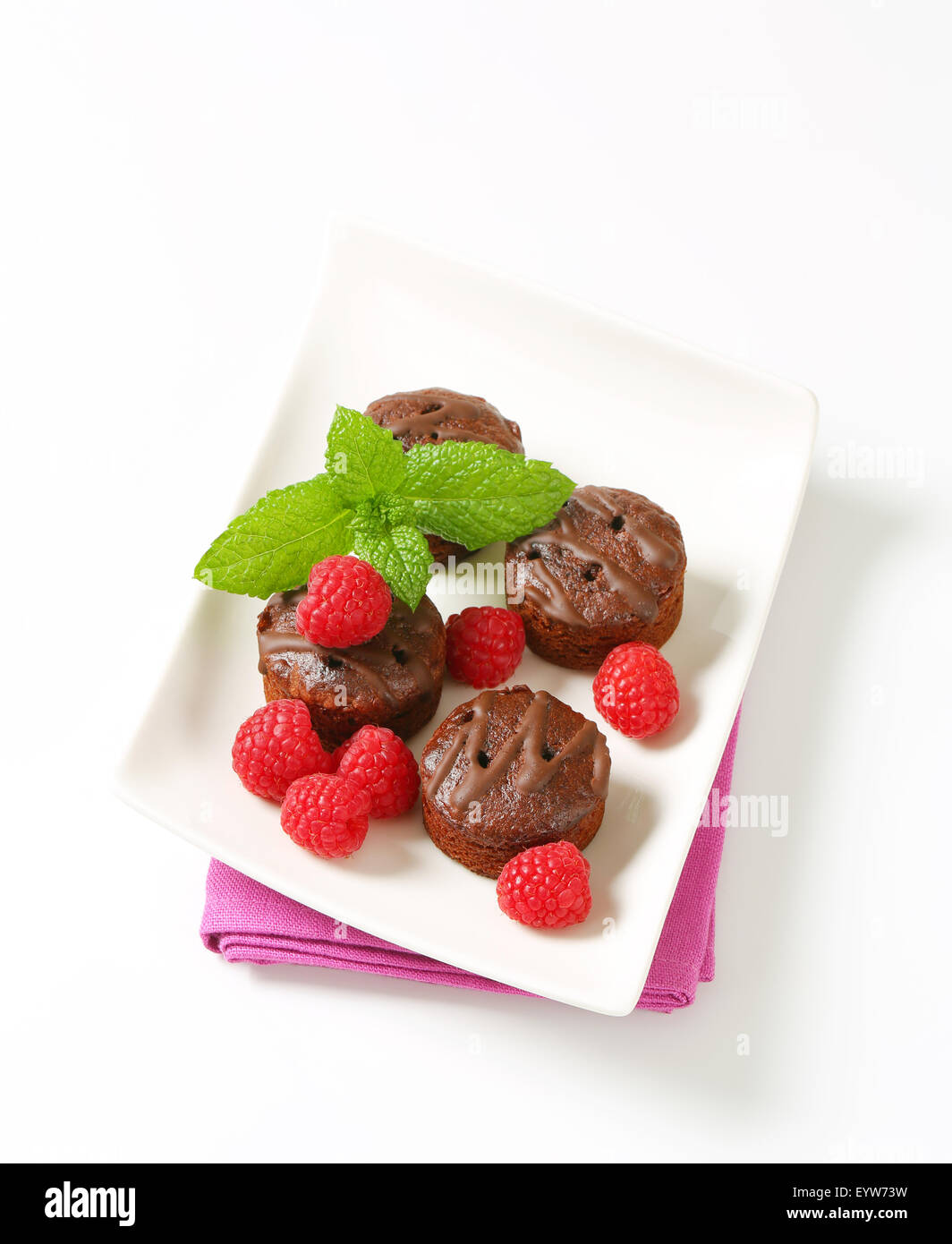 Mini chocolate cakes with raspberry filling Stock Photo - Alamy