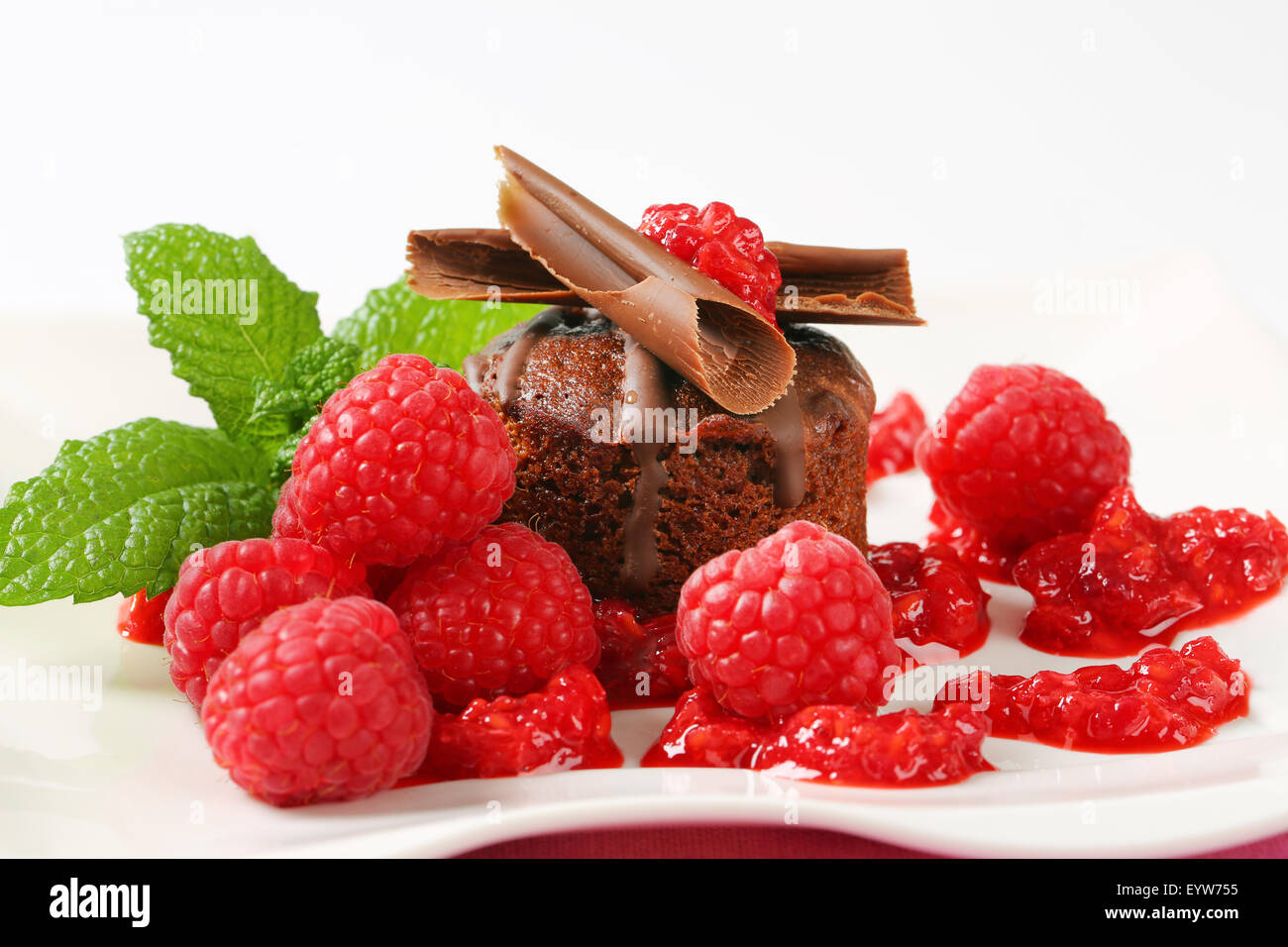 Mini chocolate cake served with fresh raspberries Stock Photo - Alamy