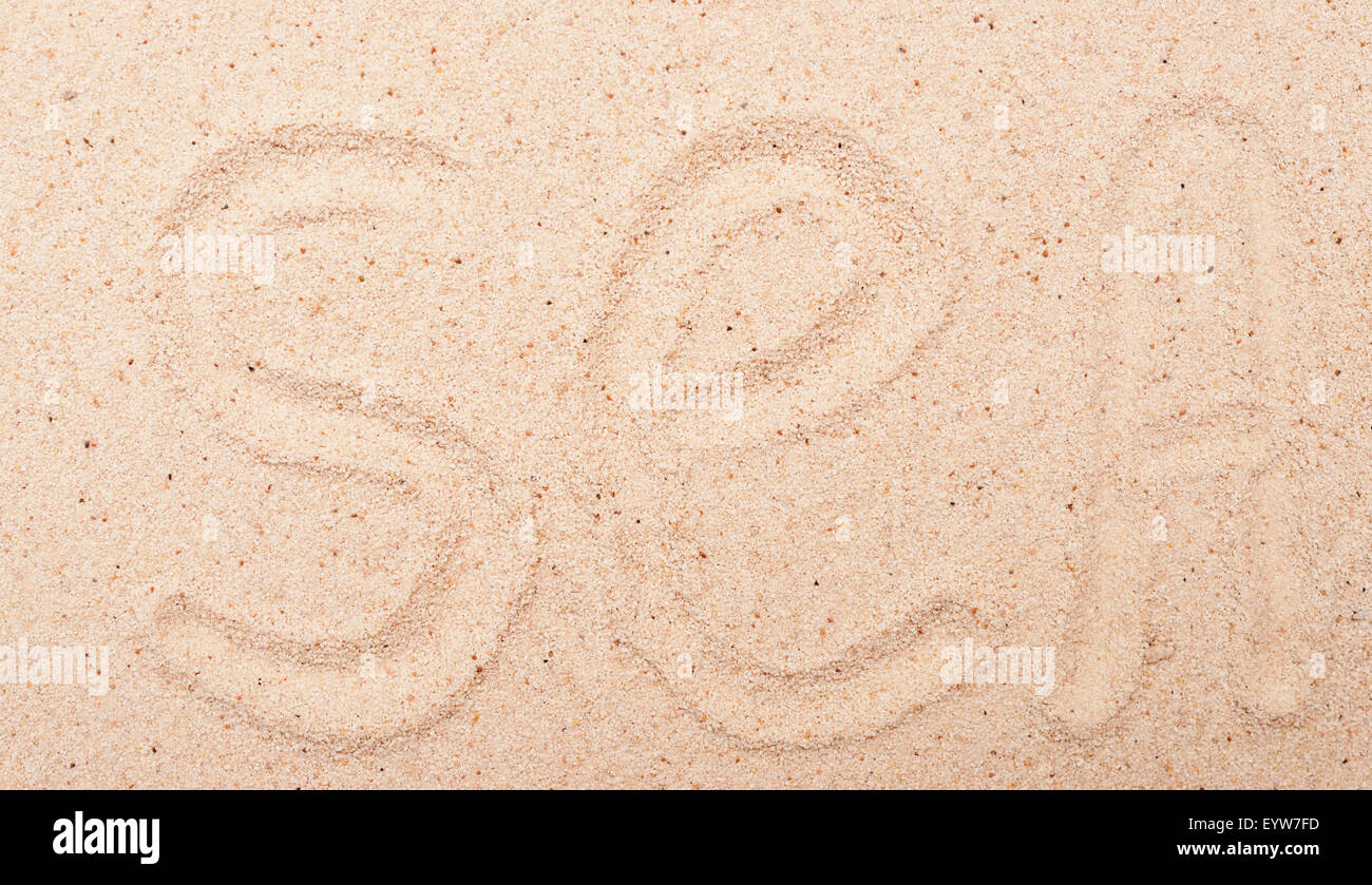 Sea writing on sand Stock Photo - Alamy