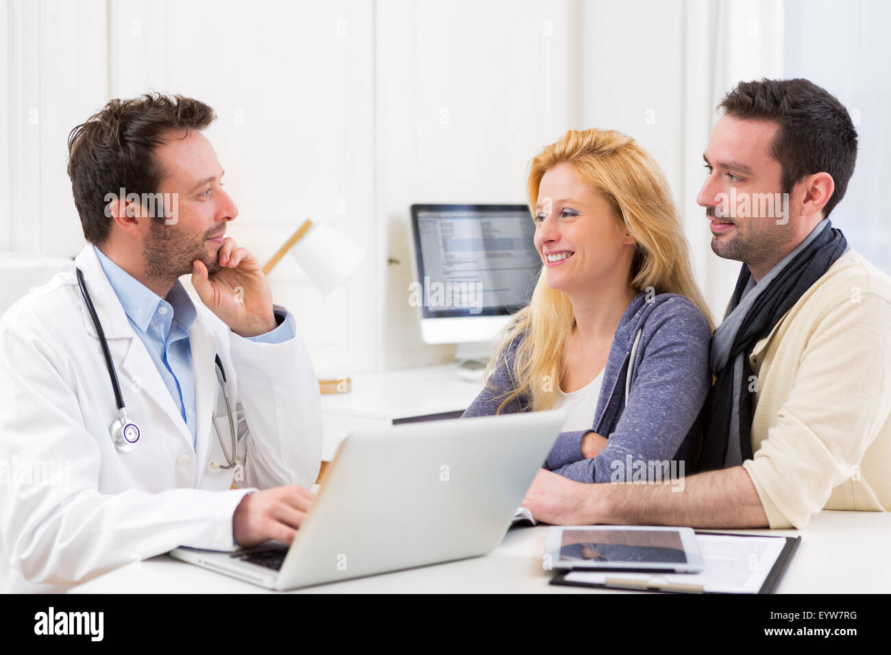 View of a Young attractive couple seeing a doctor Stock Photo - Alamy