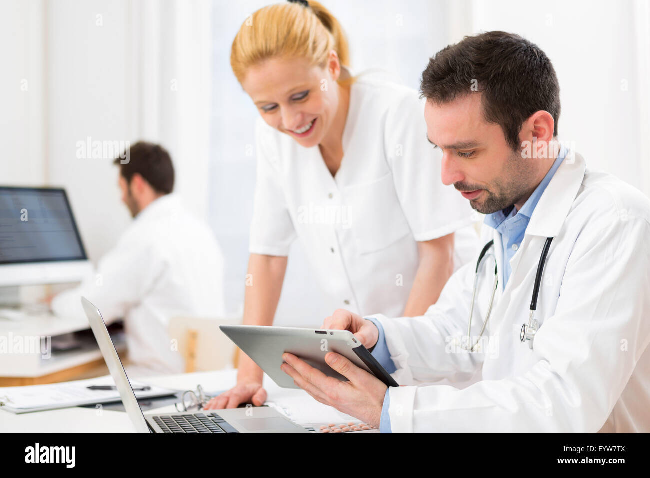 View of a Doctor and an assistant working together at the hospital ...