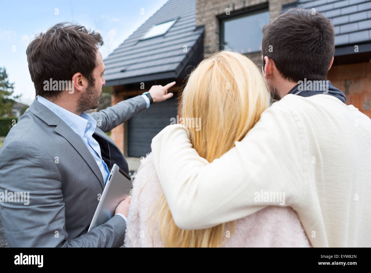 View of a Real estate agent shows details to customers Stock Photo - Alamy