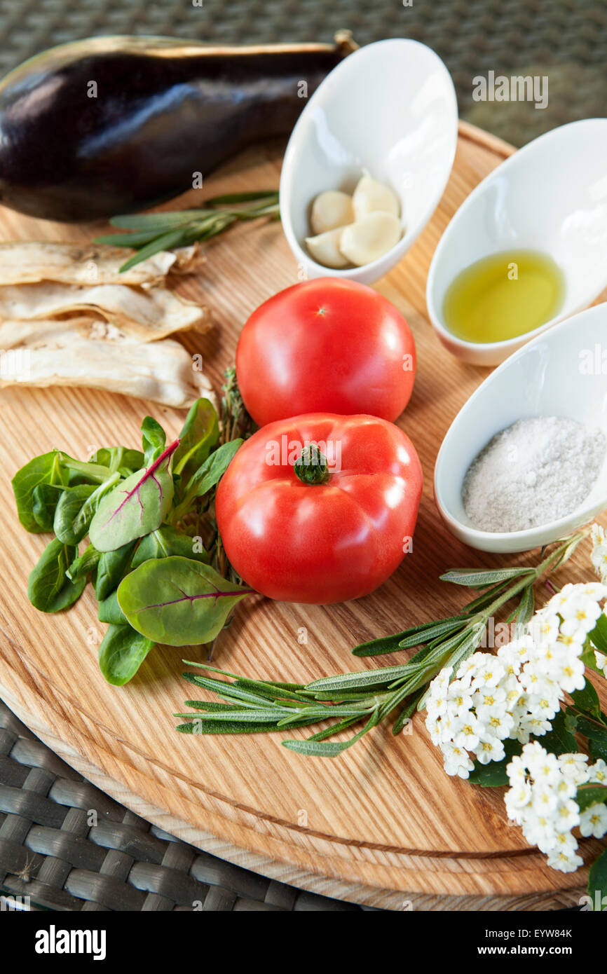 Still life with fresh cooking ingredients on wooden plate Stock Photo ...
