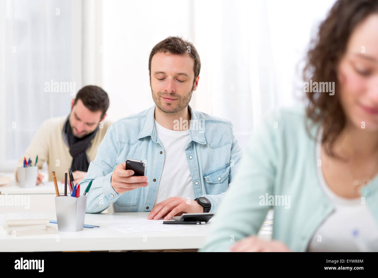 Student using mobile during class hi-res stock photography and images ...